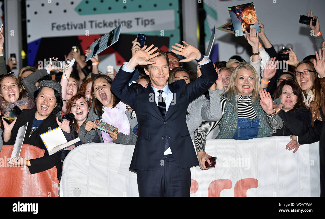 Benedict Cumberbatch poses for a photo with fans as he arrives for the ...