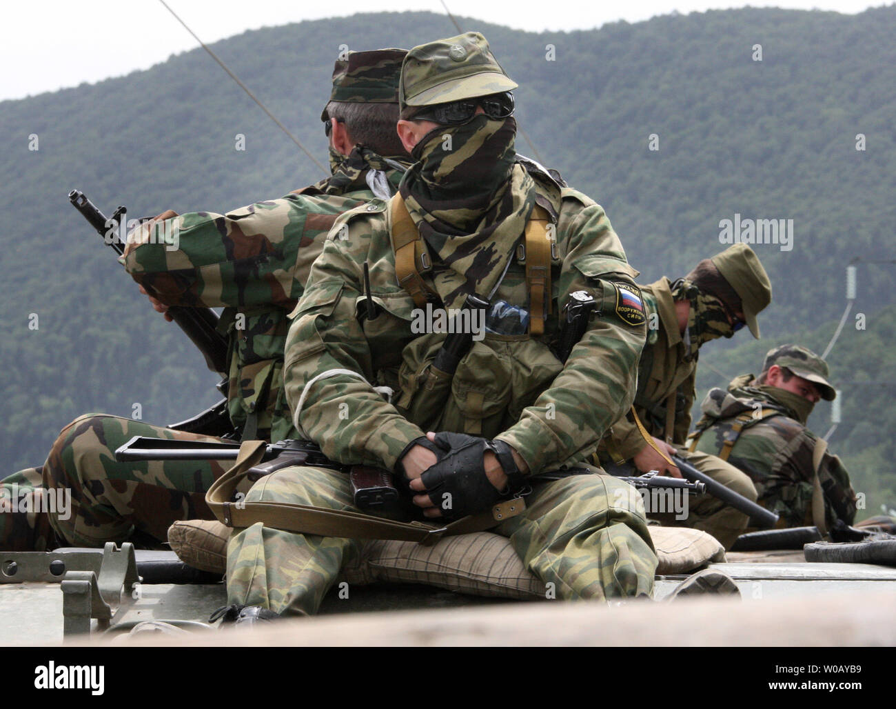 Russian soldiers sit on top of an APC on the road to the South Ossetian ...