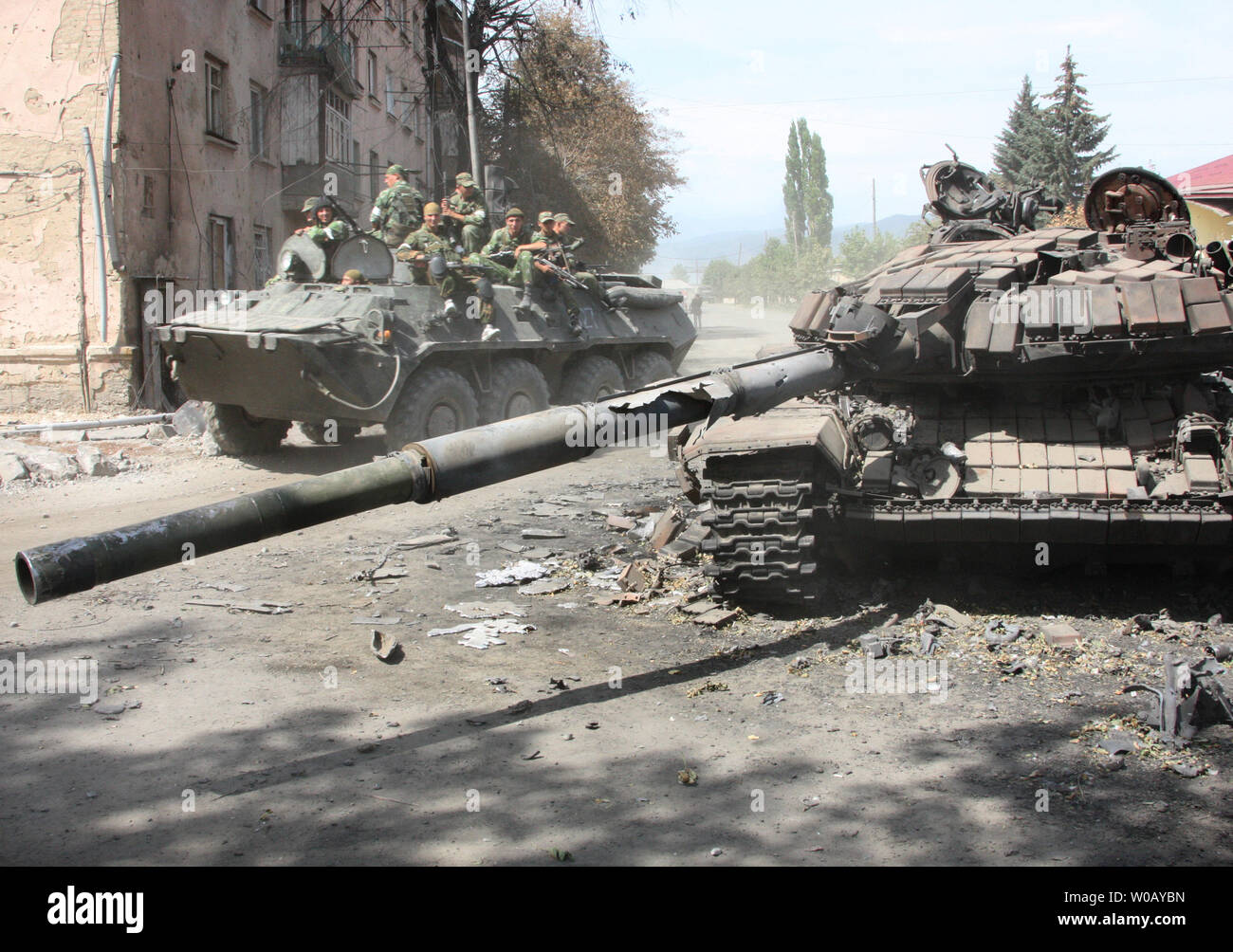 Russian soldiers roll past a destroyed Georgian tank in the center of ...