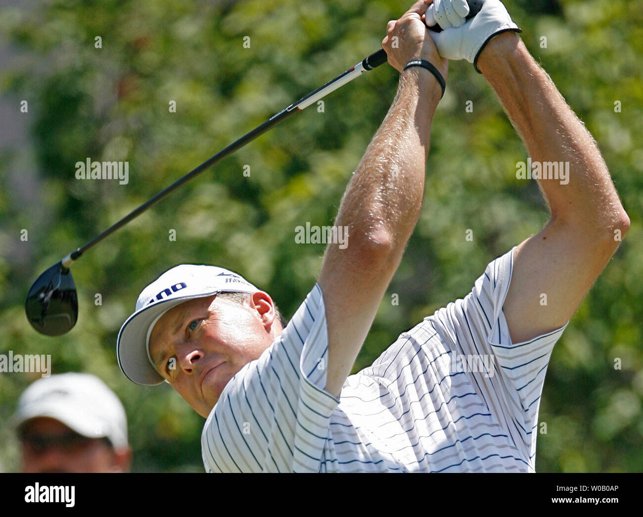 Bob Tway watches his tee shot to begin play from the first hole in the ...