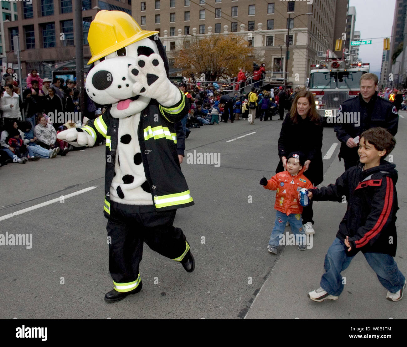 Smokey the firemen's mascot is popular with the kids as he passes ...