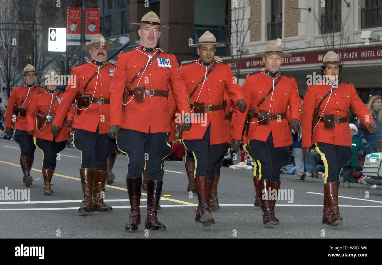 Members of the Royal Canadian Mounted Police (RCMP) march past ...
