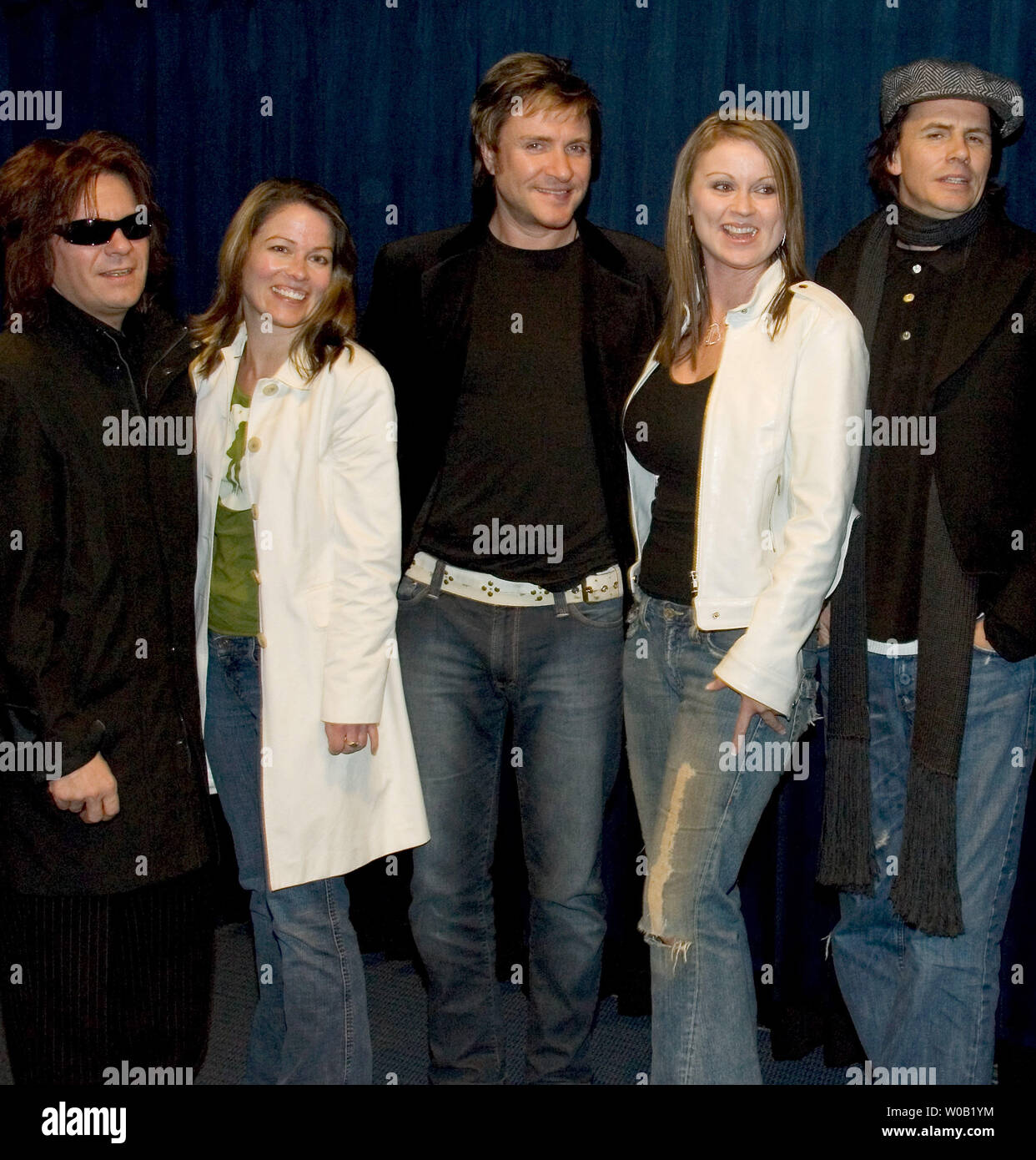 Two local entertainment reporters pose with Andy Taylor (L), Simon ...