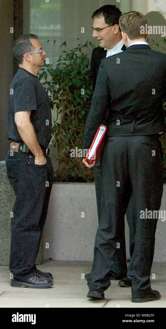John Lynch talks to his lawyer Dave Sutherland during a break in trial ...