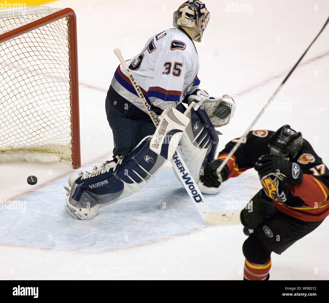 Visiting Calgary Flames Chris Simon scores unassisted on Vancouver ...