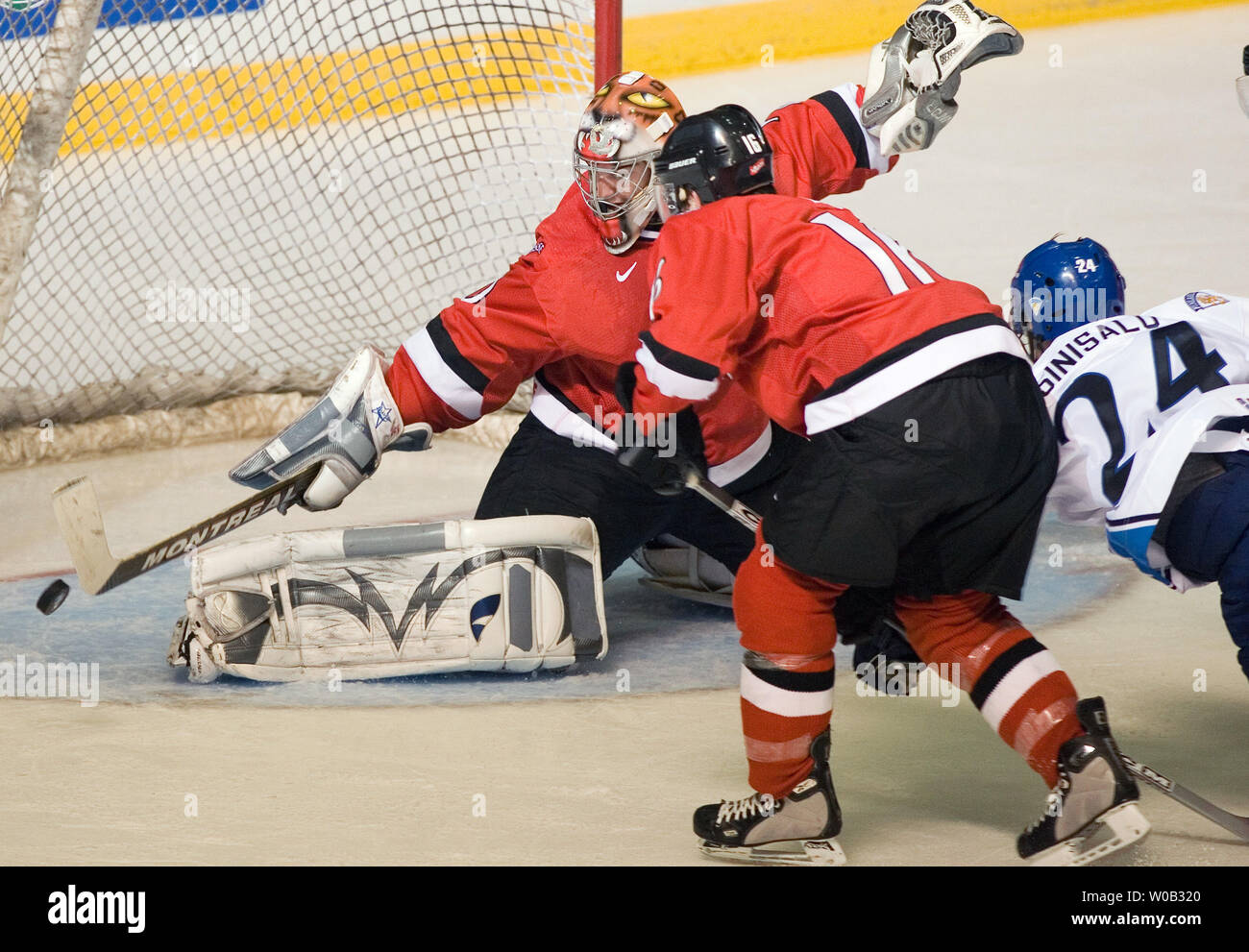 Team Switzerland's goalie Reto Berra makes a stick save ahead of team ...