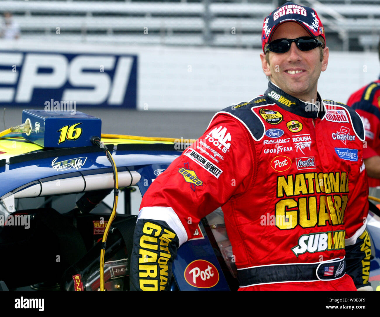 NASCAR race car driver Greg Biffle stands by his race car as he awaits ...
