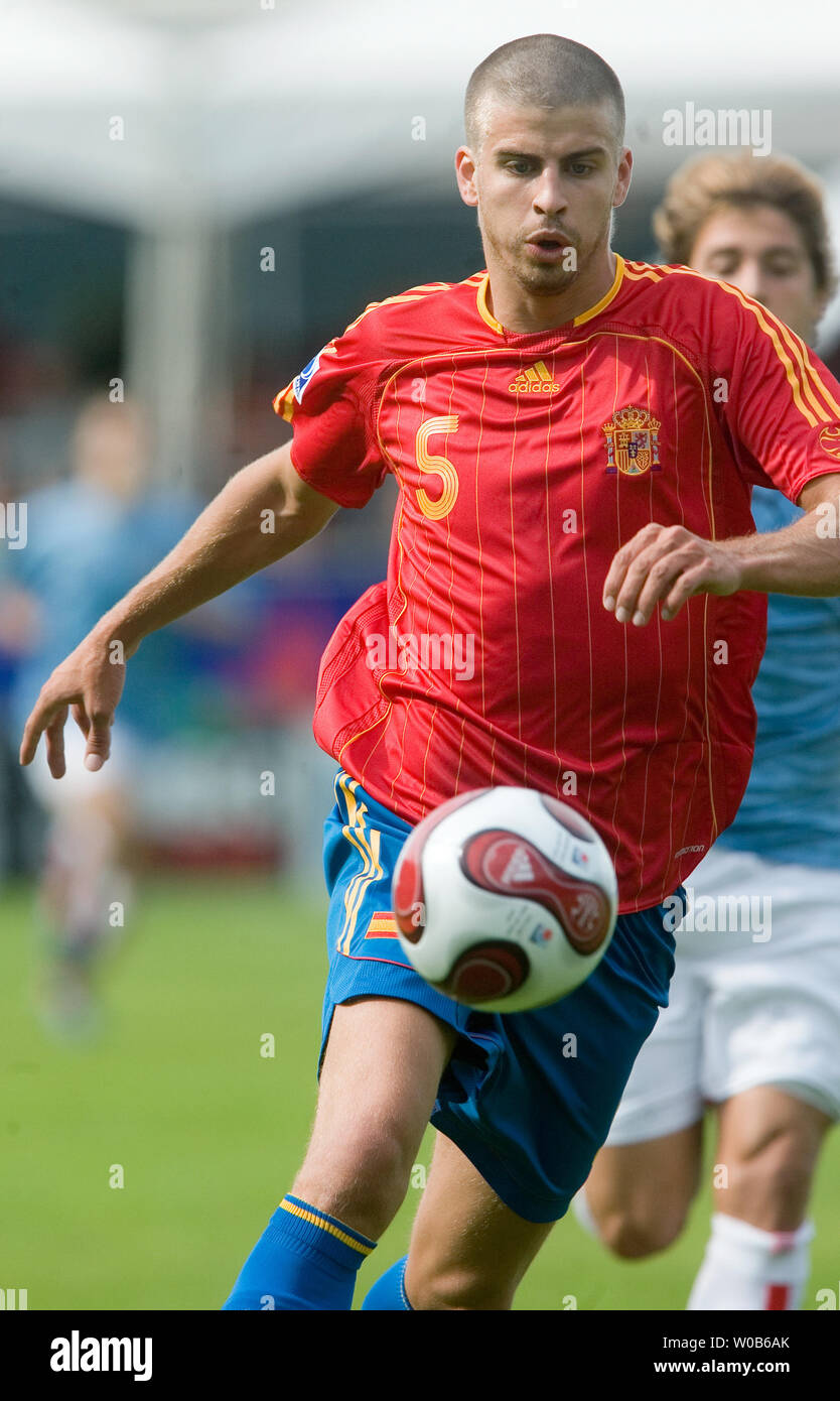 Spain's Gerard Pique drives the ball down field during the first half ...