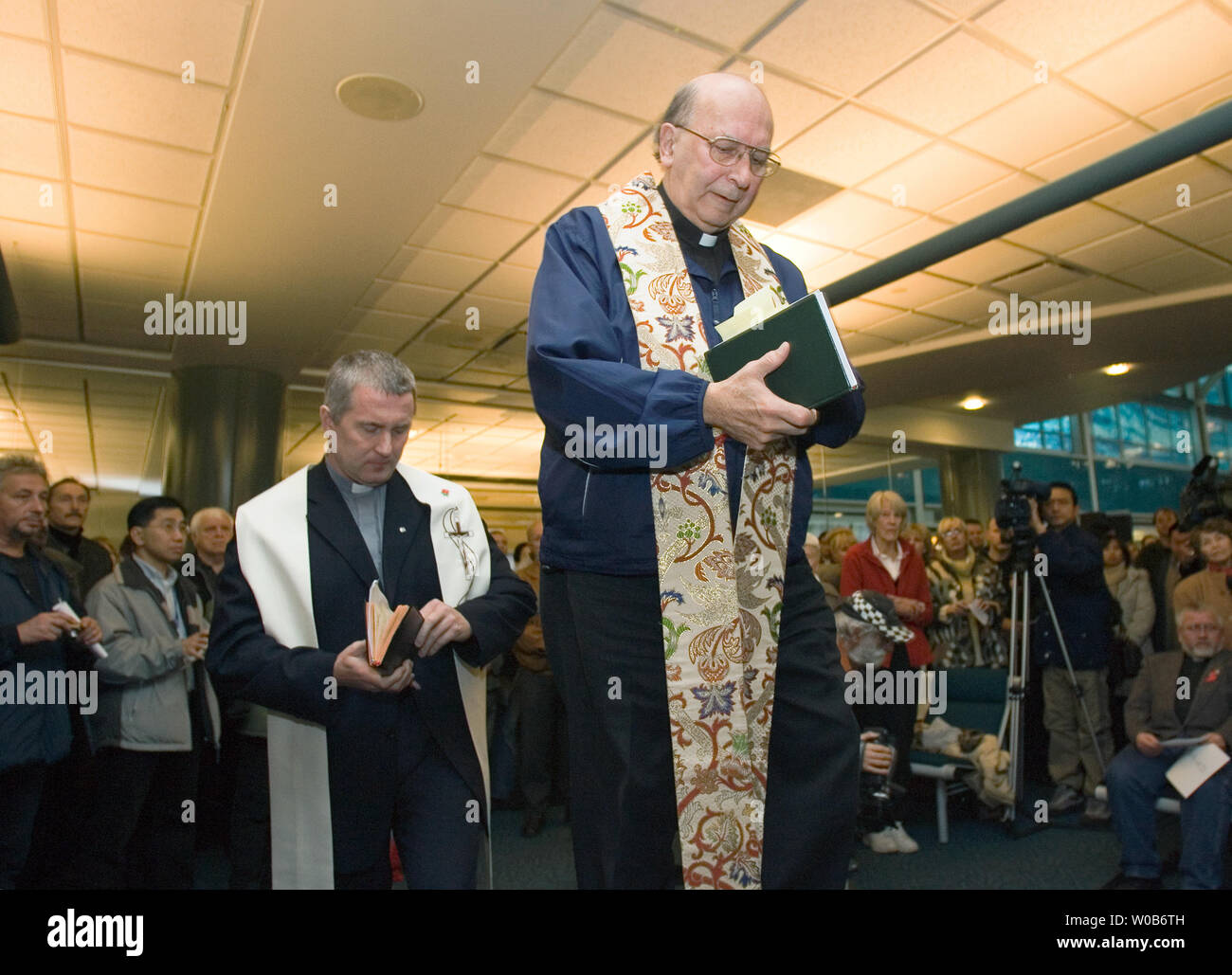 Reverand Angelo de Pompa (R) and Pastor Jacek Nosowicz walk to the ...