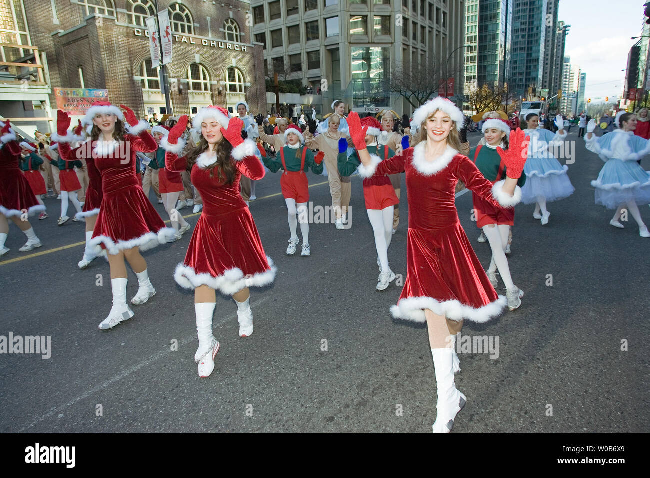 Santa's helpers dance down Georgia Street during the fourth annual ...