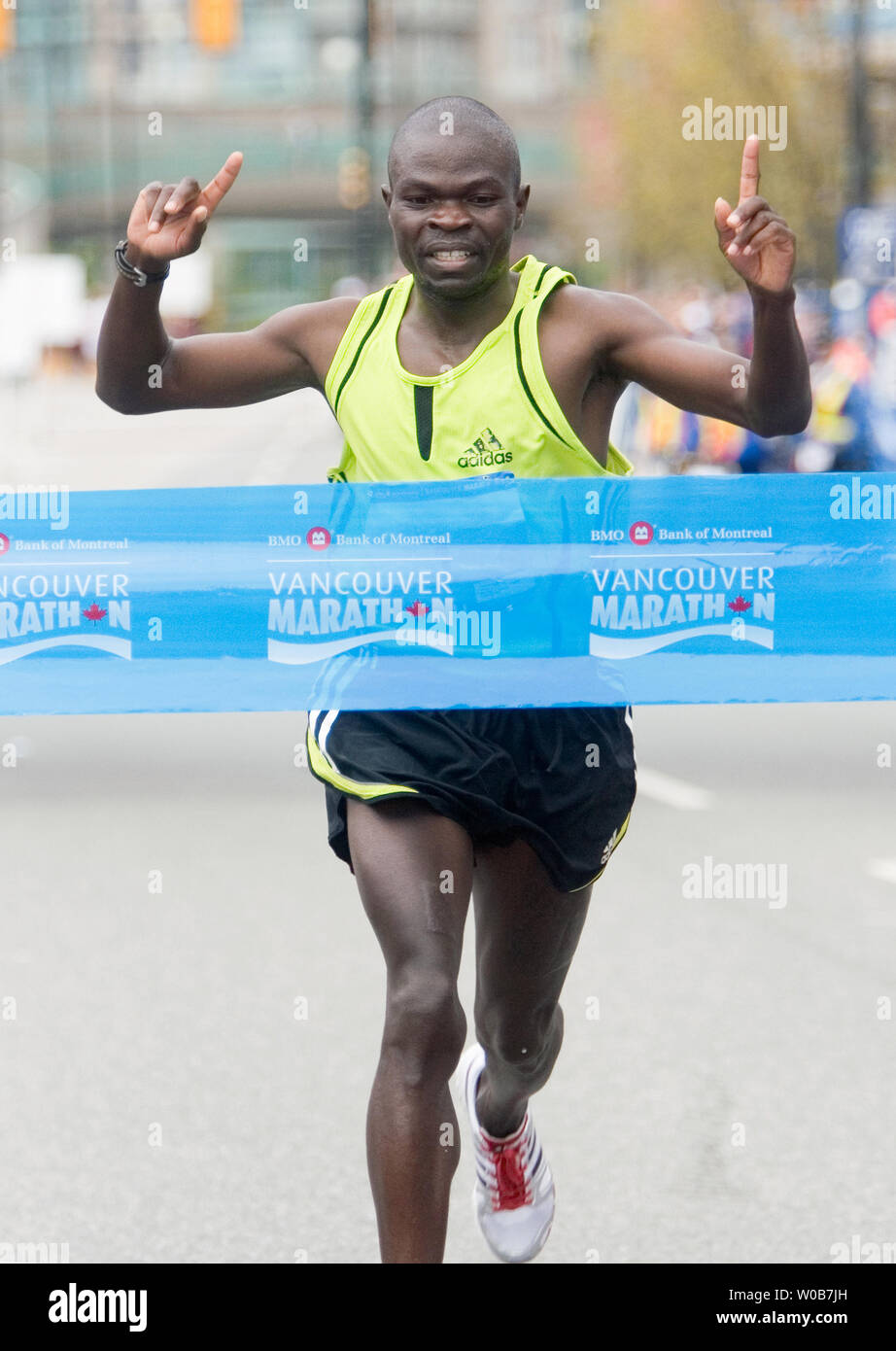Kenyan Thomas Omwenga from Tampa, Florida crosses the finish winning ...