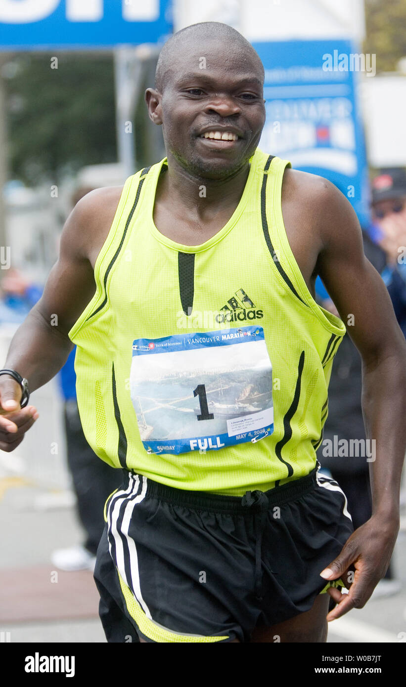 Kenyan Thomas Omwenga from Tampa, Florida crosses the finish winning ...