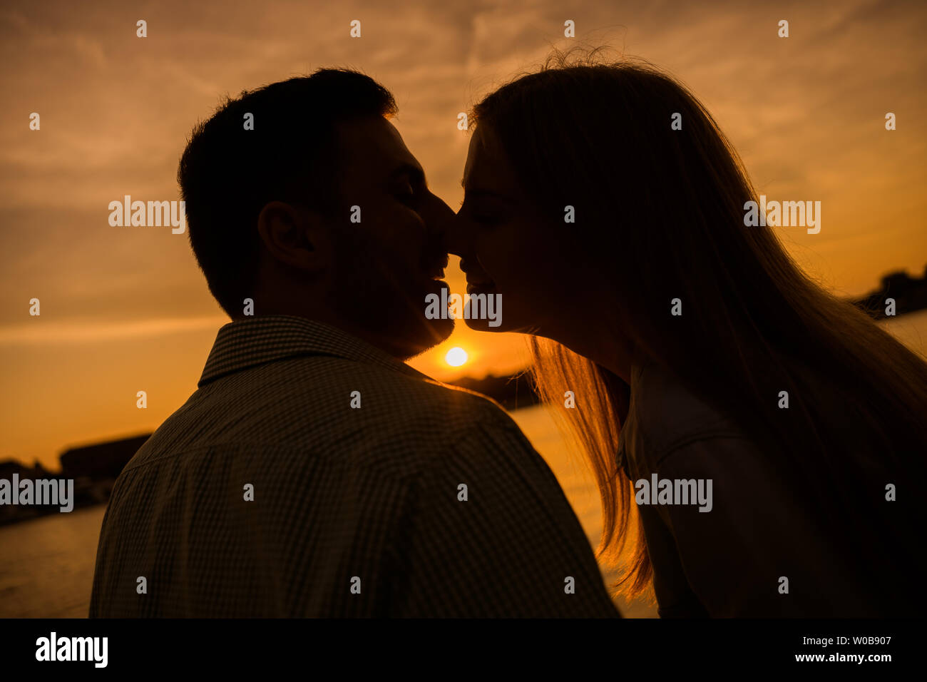 Happy couple in love is enjoying sunset in the city Stock Photo - Alamy