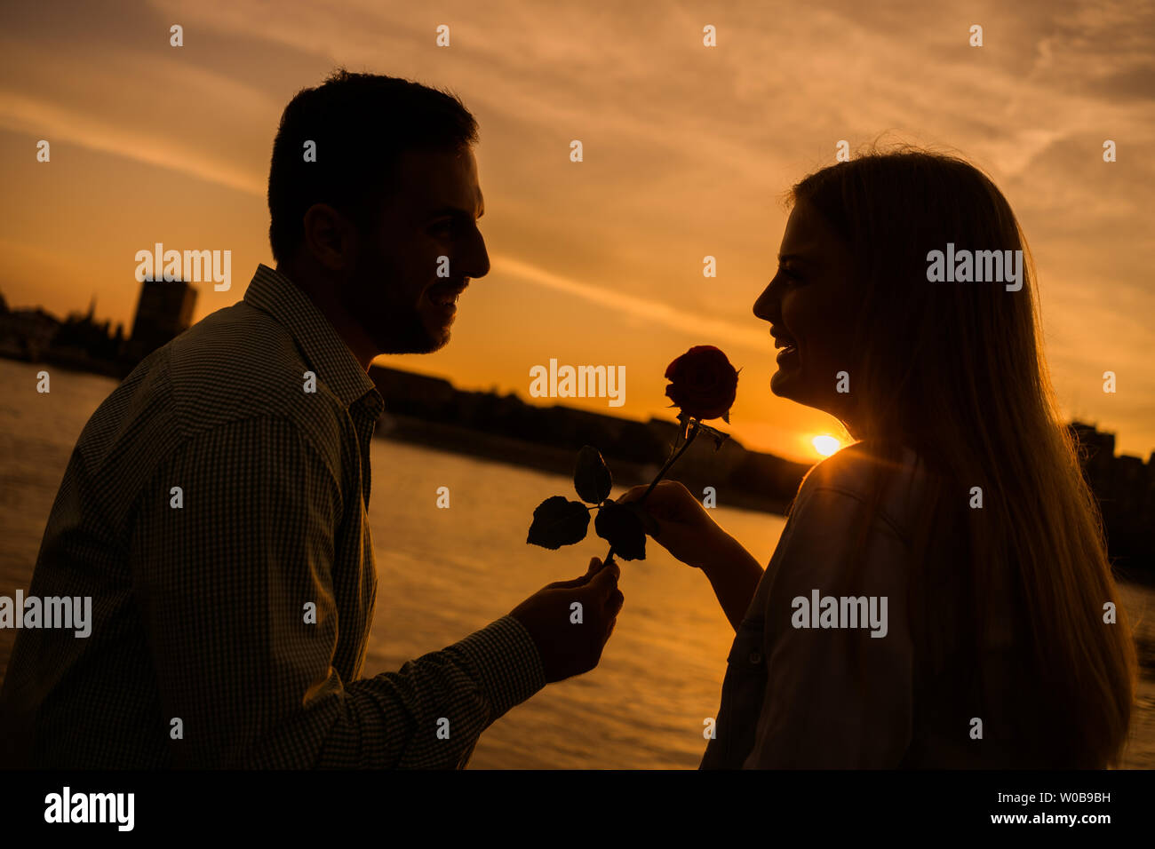 Happy couple in love is enjoying sunset in the city Stock Photo - Alamy