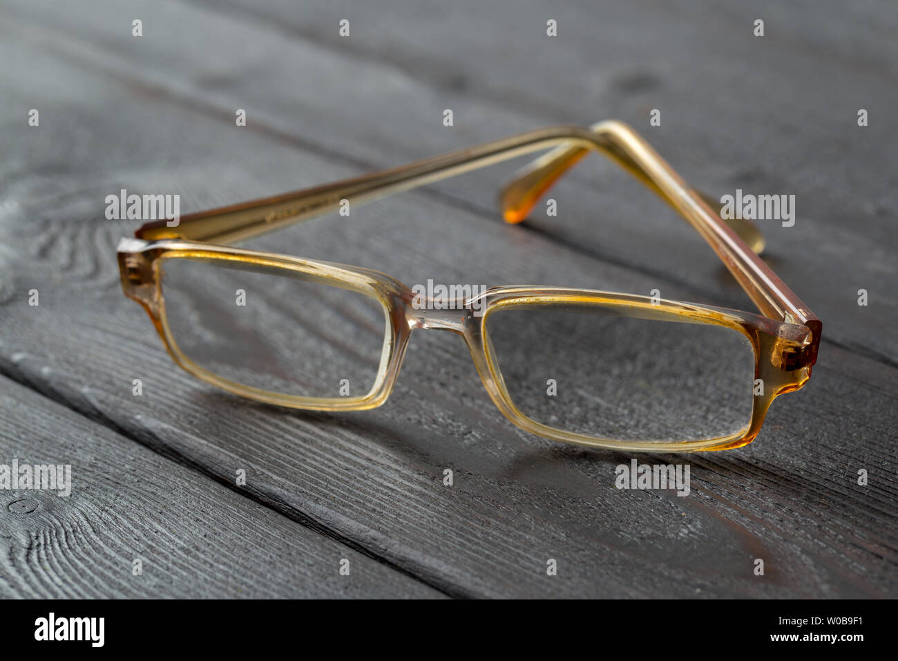 eyeglasses on wooden table Stock Photo - Alamy