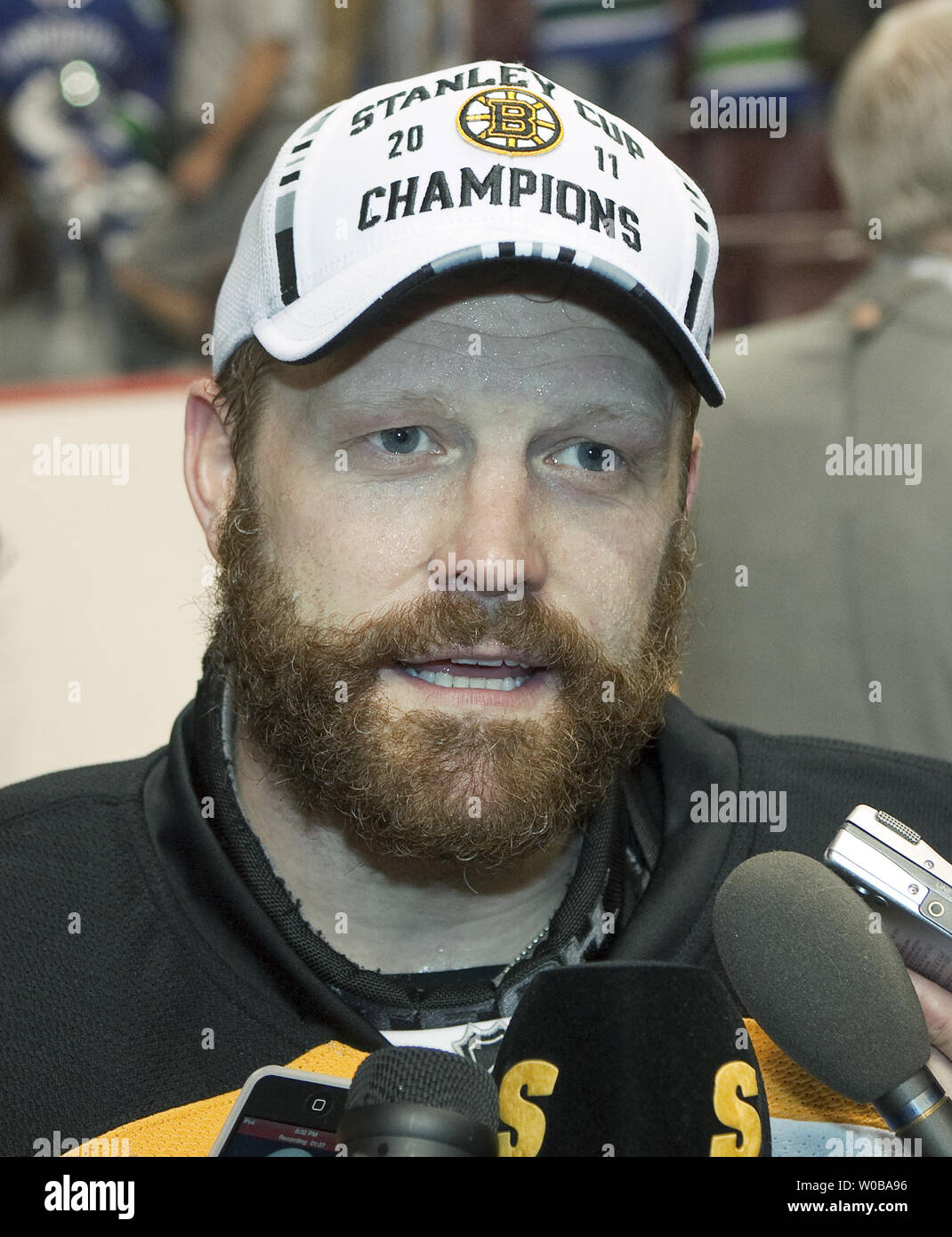 Boston Bruins goalie Tim Thomas talks to reporters as his team ...