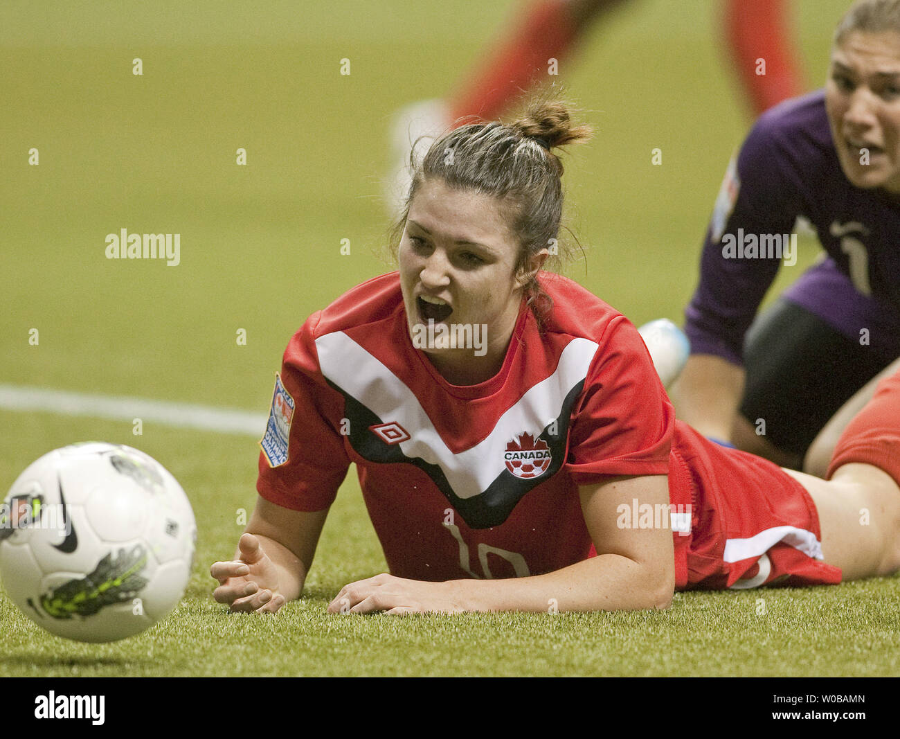 USA's goalkeeper Hope Solo and Canada's Christina Julien (front) watch ...