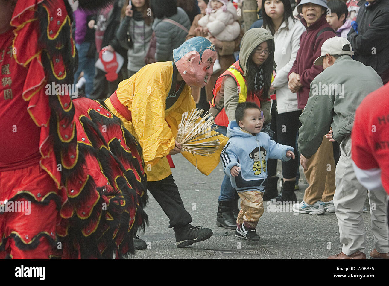 A young boy is guided off the course of the 2013 Chinese New Year ...