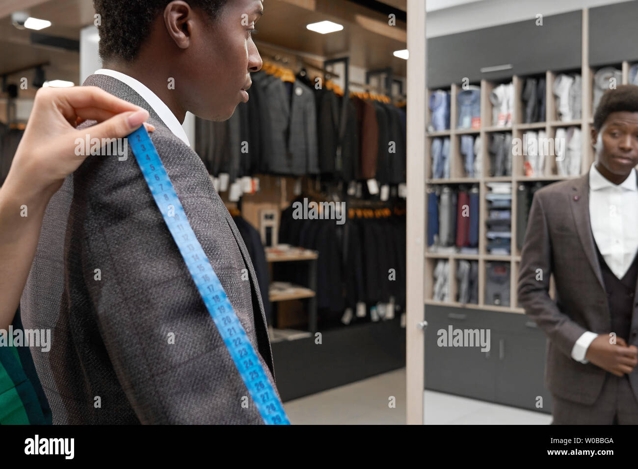 Close up of assistant hand holding measuring tape and measuring sleeve ...