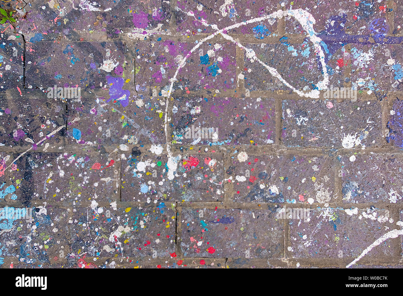 Colorful Paint Splattered and Dripped on old Bricks and Mortar surface ...