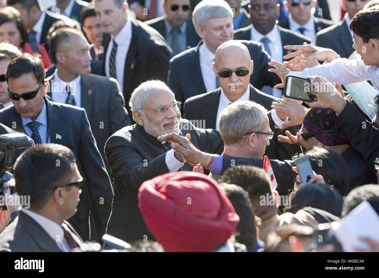 India's Prime Minister Narendra Modi greets cheering crowds at the ...