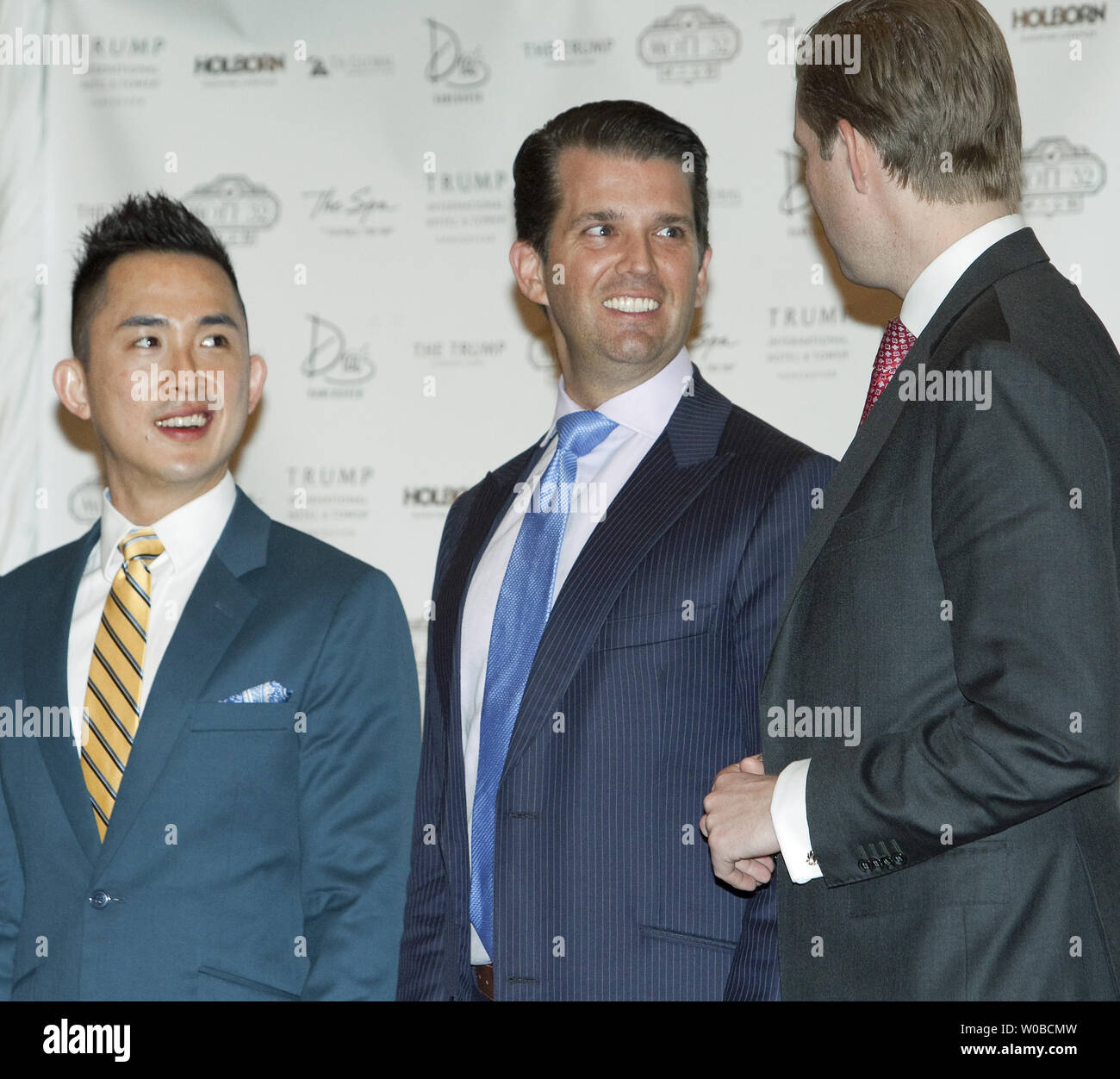 Eric Trump (R) talks to his brother Donald Trump Jr. and Joo Kim Tiah ...