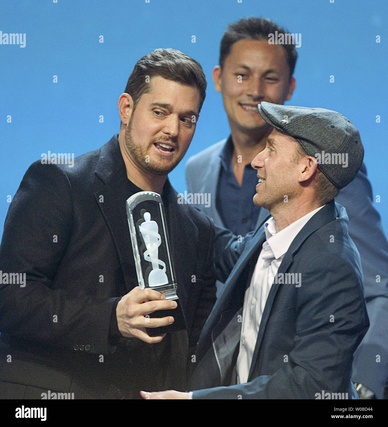 Michael Buble (L) invites his co-producers onstage after receiving the ...