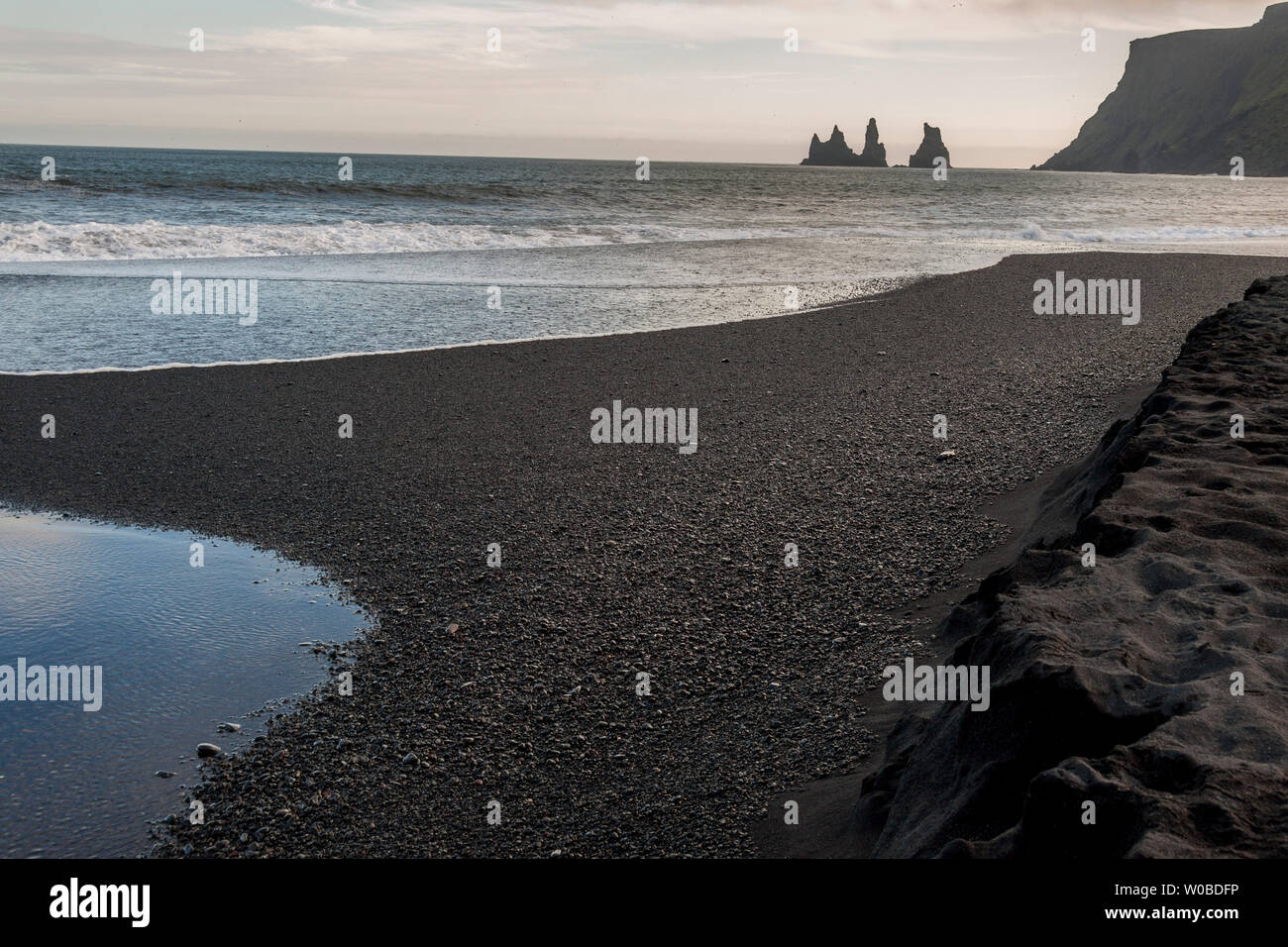 Reynisdrangar rock formations and the mount Reynisfjall. Black beach in ...