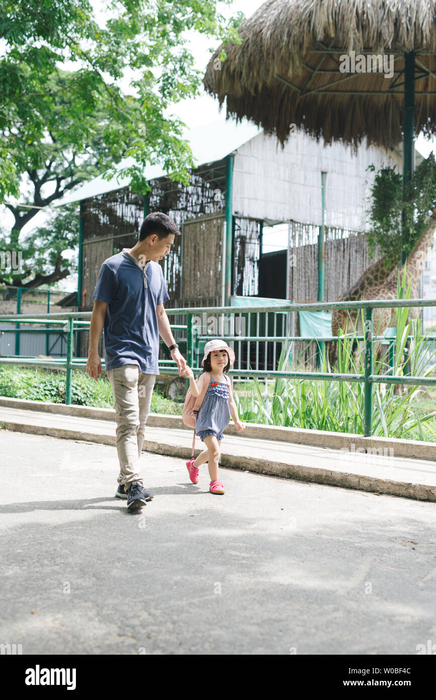 Happy family having fun with animals safari park on warm summer day ...