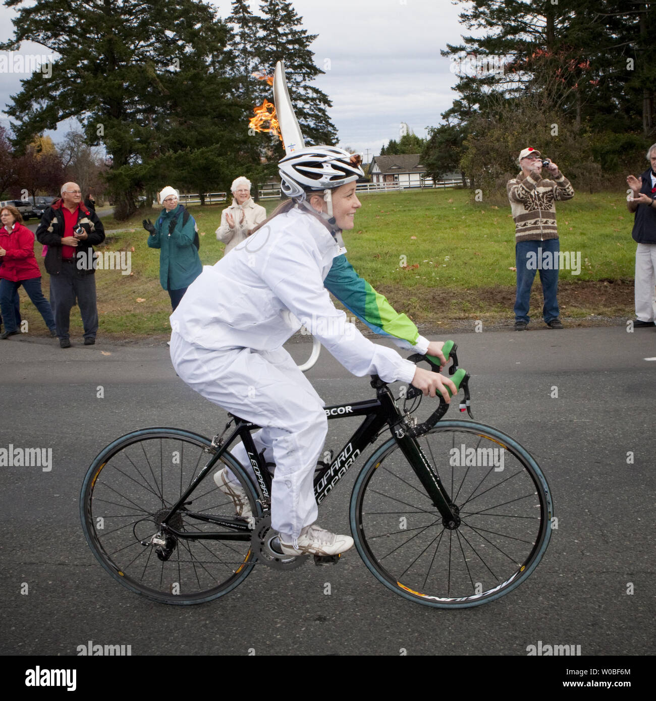 The 54th torch bearer, Olympic cyclist Errine Willock rides her leg of ...