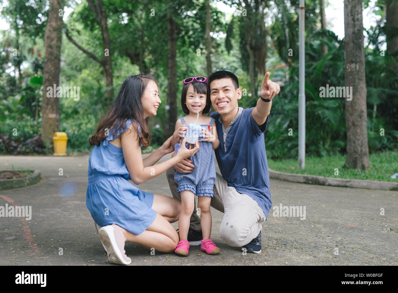 Happy young couple spending time with their daughter Stock Photo - Alamy