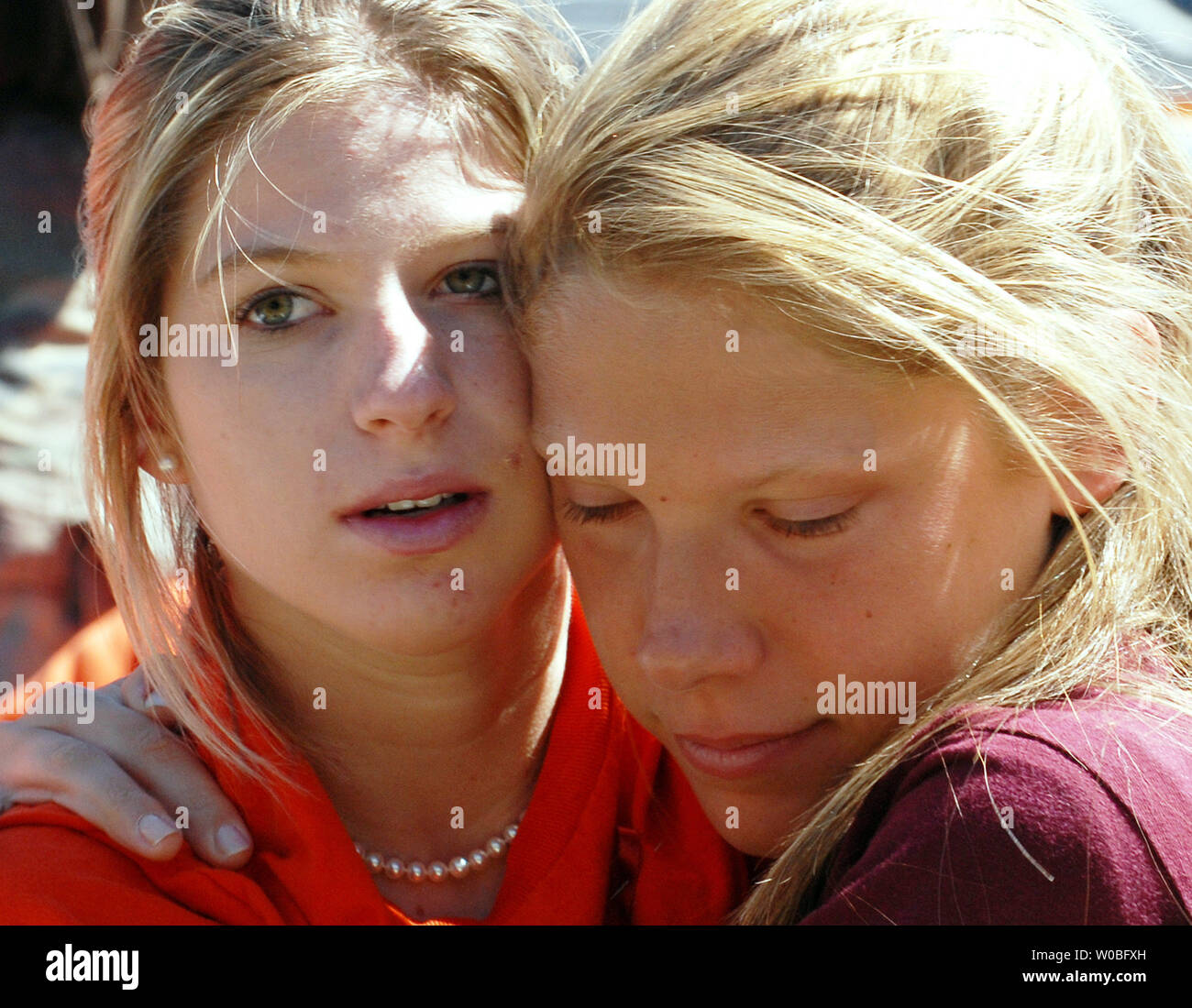 Virginia Tech freshmen Sarah Peet and Sarah Carlson (R) comfort each ...