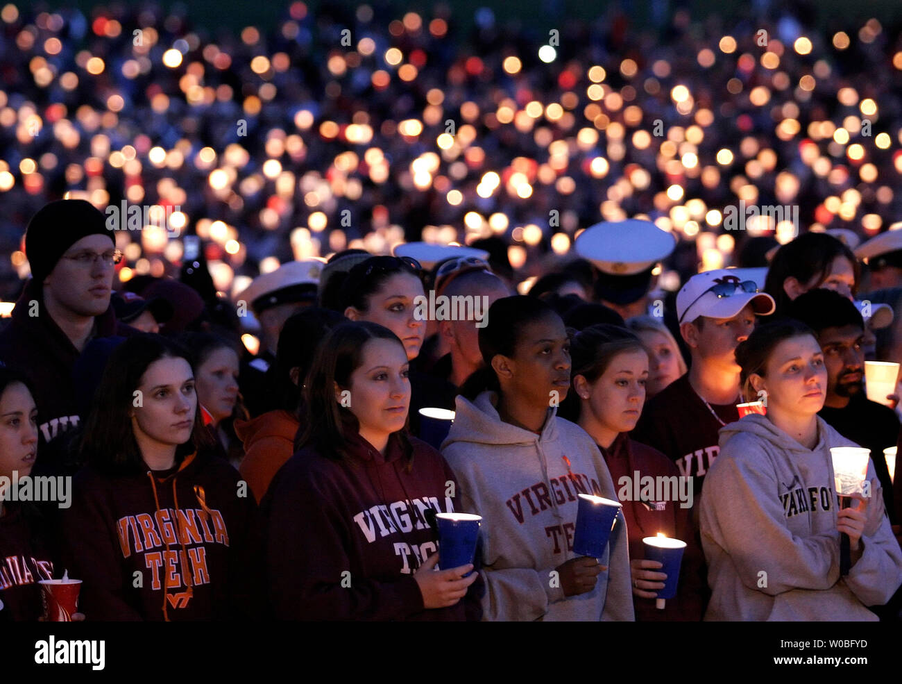 Virginia Tech students attend a candlelight vigil for the 33 people who ...