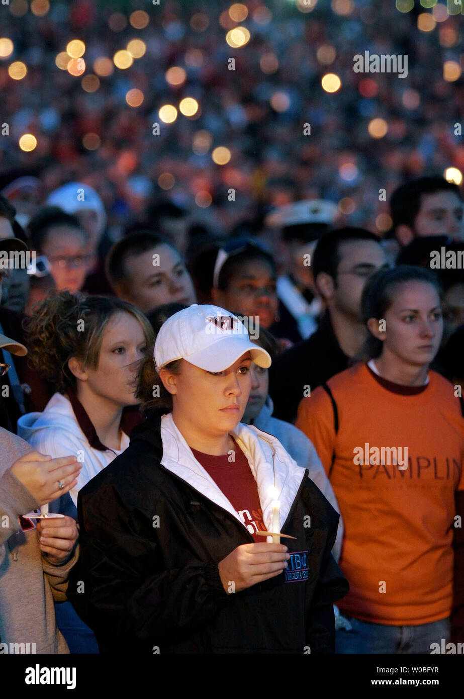 Virginia Tech students attend a candlelight vigil for the 33 people who ...