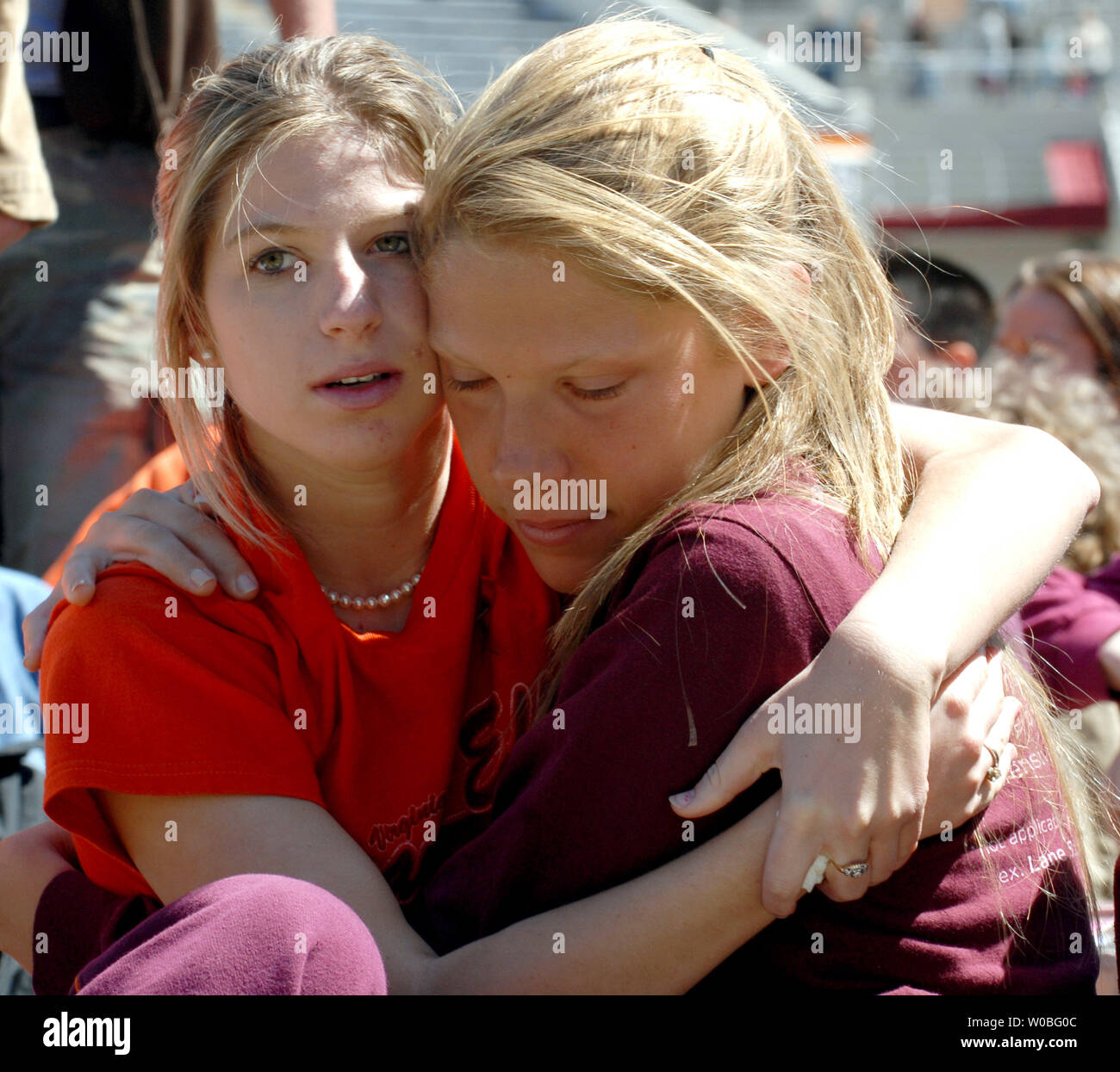 Virginia Tech freshmen Sarah Peet and Sarah Carlson (R) comfort each ...