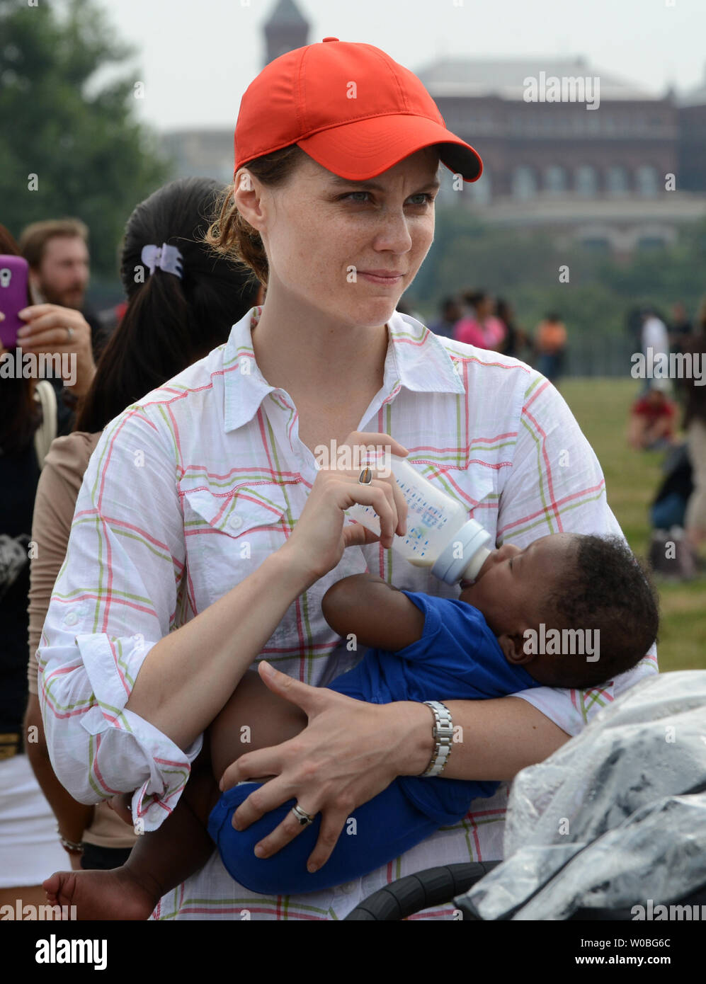 Elizabeth Lien, of Arlington, Virginia, holds her son Nicholas as she ...