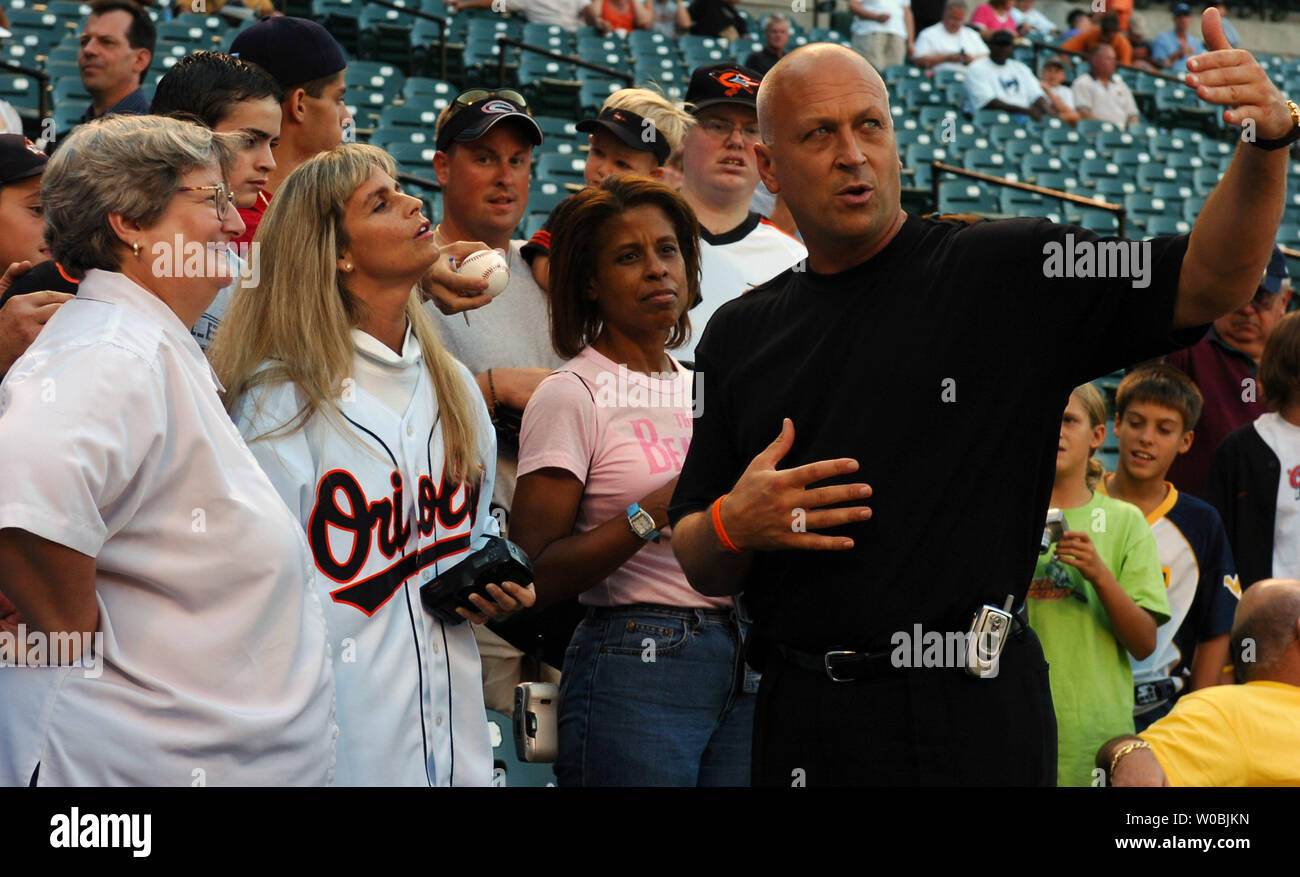 Former Baltimore Orioles star Cal Ripken Jr. goes into the stands to ...