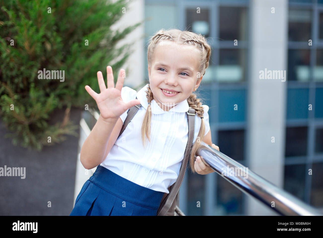 Happy smiling girl is going to school for the first time with bag go to ...