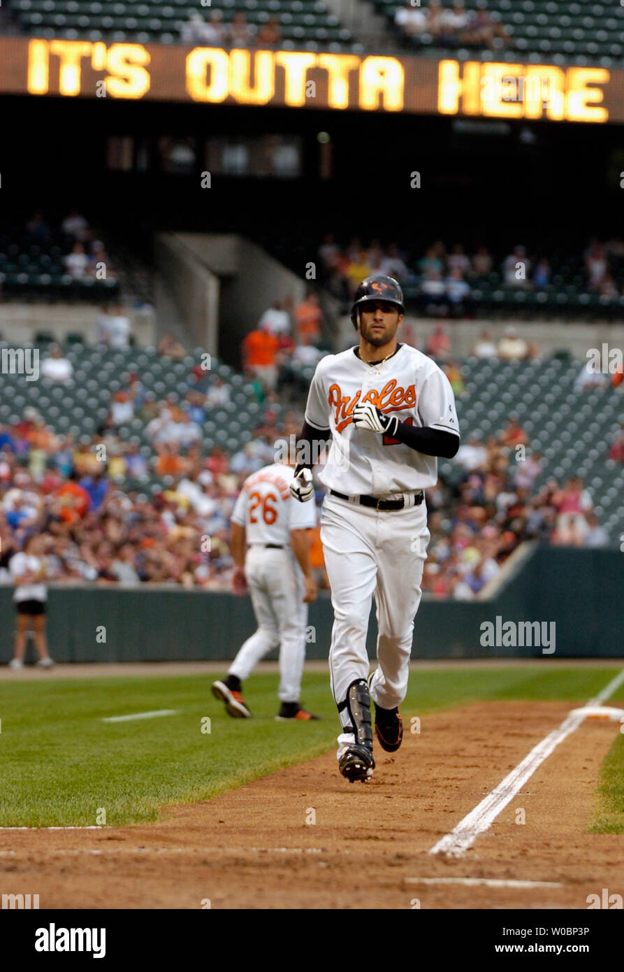 The Baltimore Orioles Nick Markakis comes into home after hitting a ...