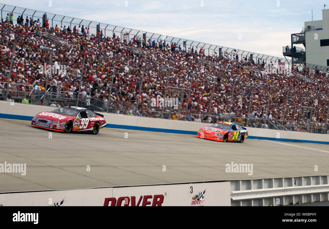 Carl Edwards (99) races in front of Jeff Gordon (24) down the front ...