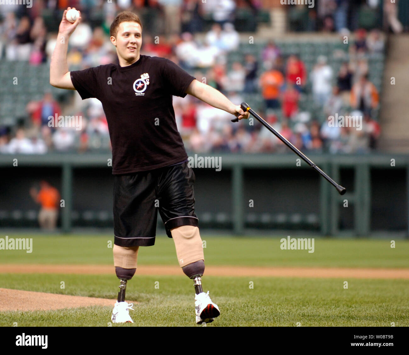Iraqi war veteran Sgt. Mark Ecker throws out the first pitch prior to ...