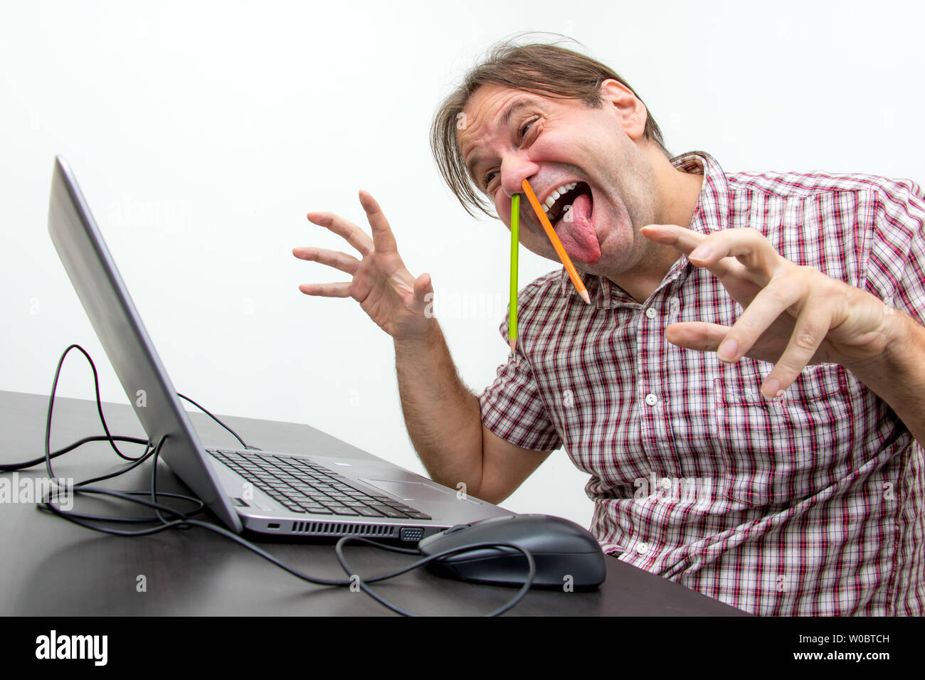 The emotional user is mad from work at the laptop. Funny man working ...