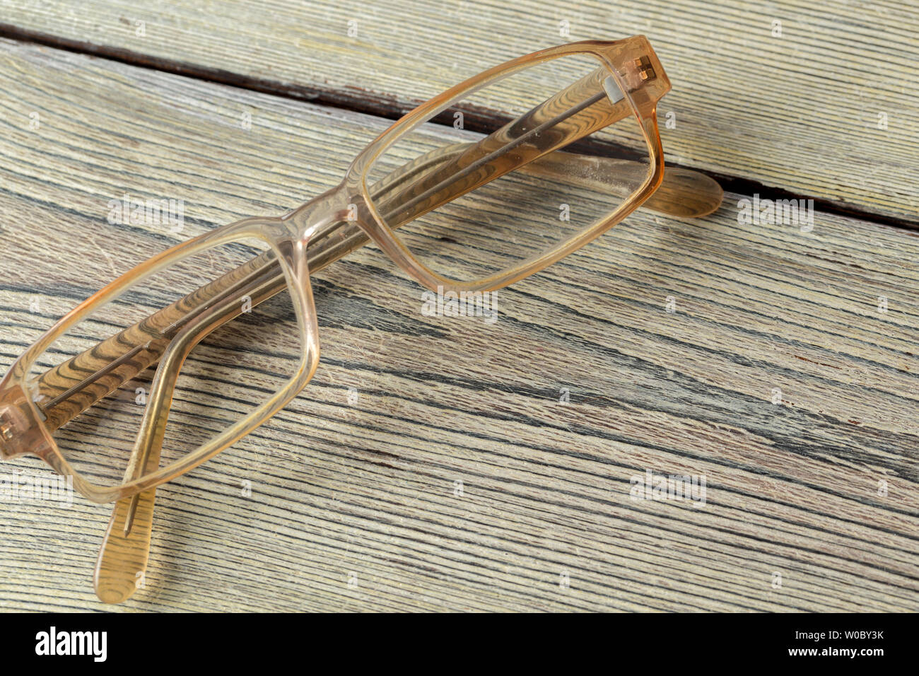 eyeglasses on wooden table Stock Photo - Alamy