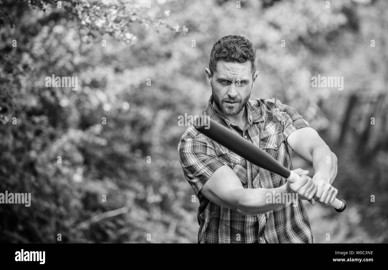 i am a criminal. outdoor sport activity. Hooligan man hits the bat ...