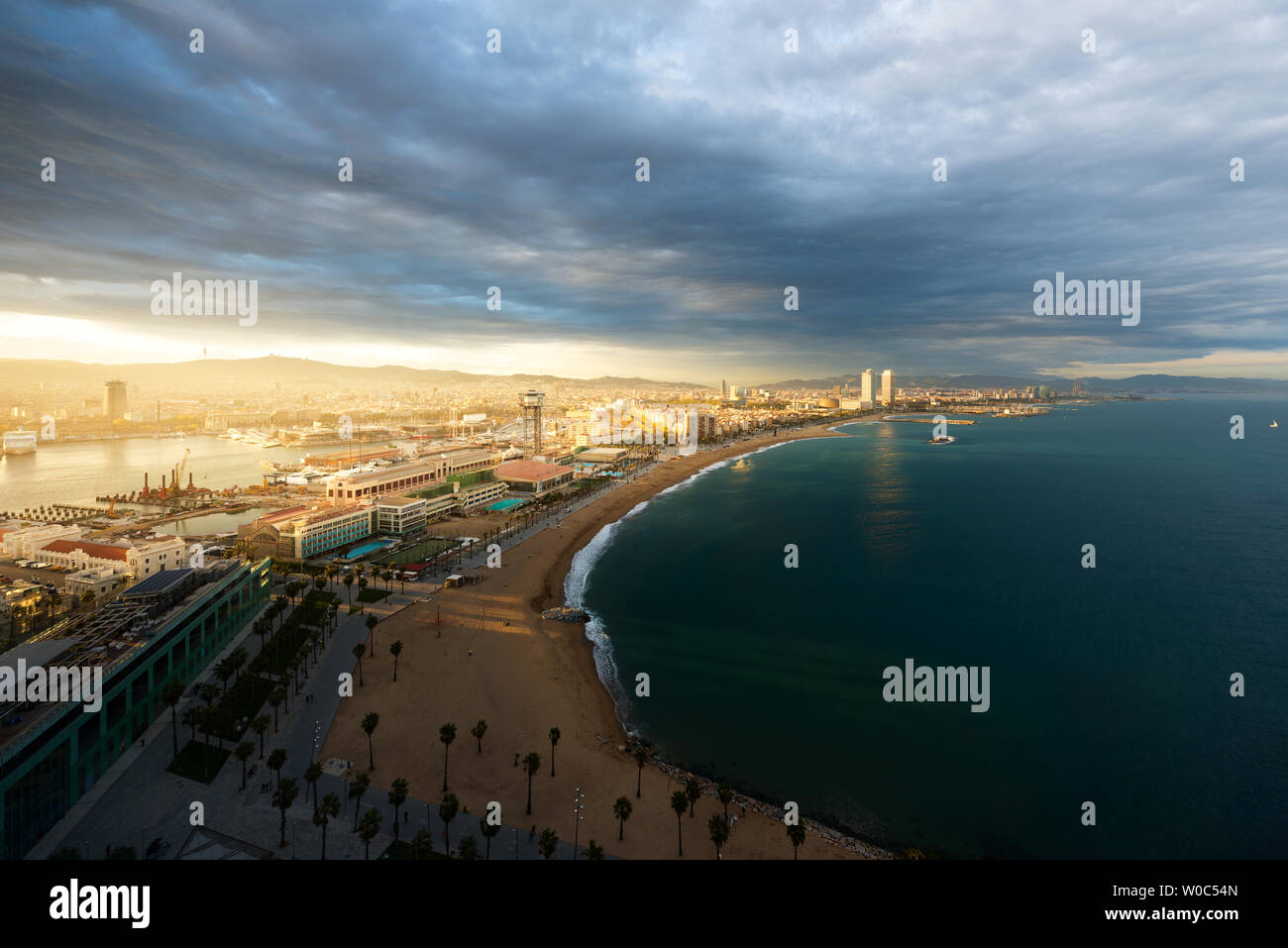 Aerial view of Barcelona Beach during sunset along seaside in Barcelona ...