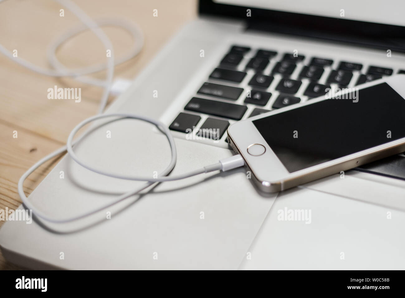 Laptops and charging phones Stock Photo - Alamy