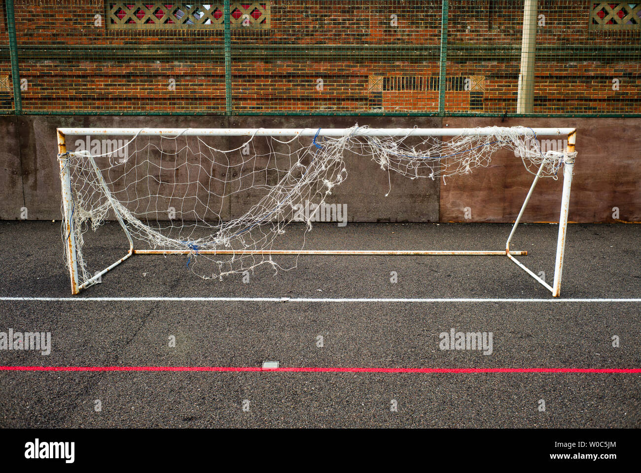 Small goalpost with torn net Stock Photo - Alamy