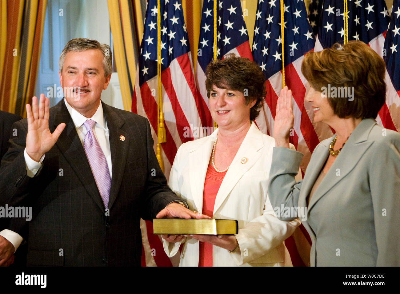 Rep. Travis Childers, D-MS, (C) is sworn-in by Speaker of the House ...