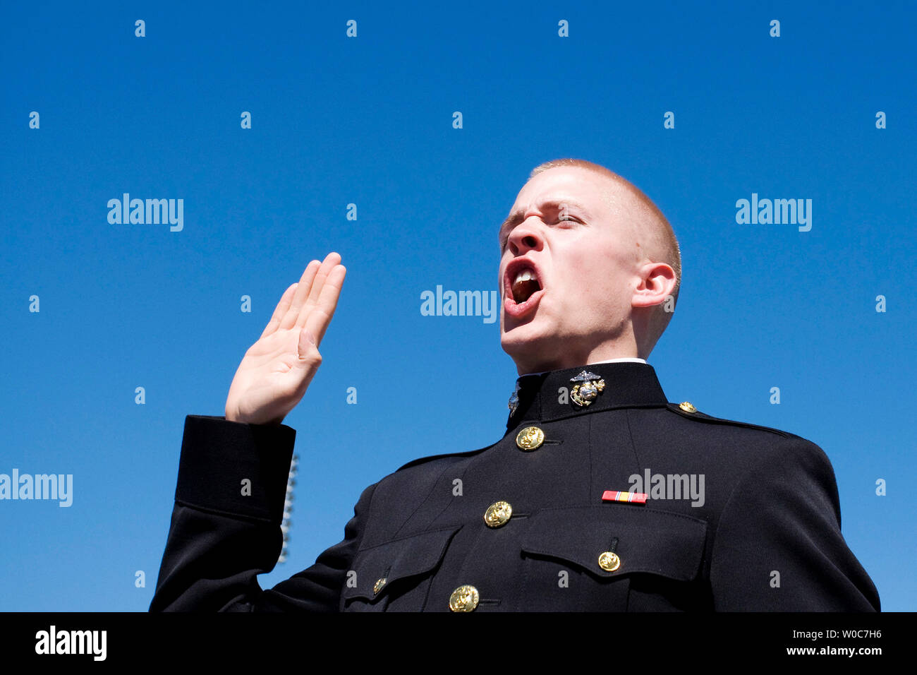 A midshipman takes his oath of office at the United States Naval ...