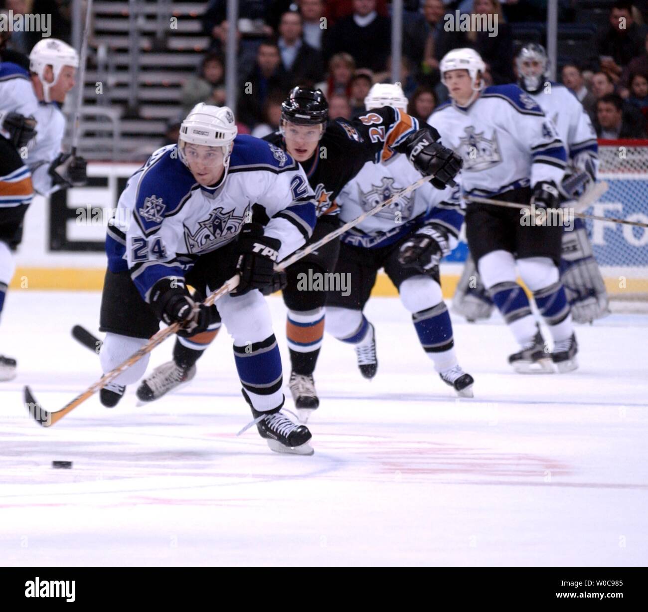 L.A. King's Alexander Frolov brings the puck down ice while being ...